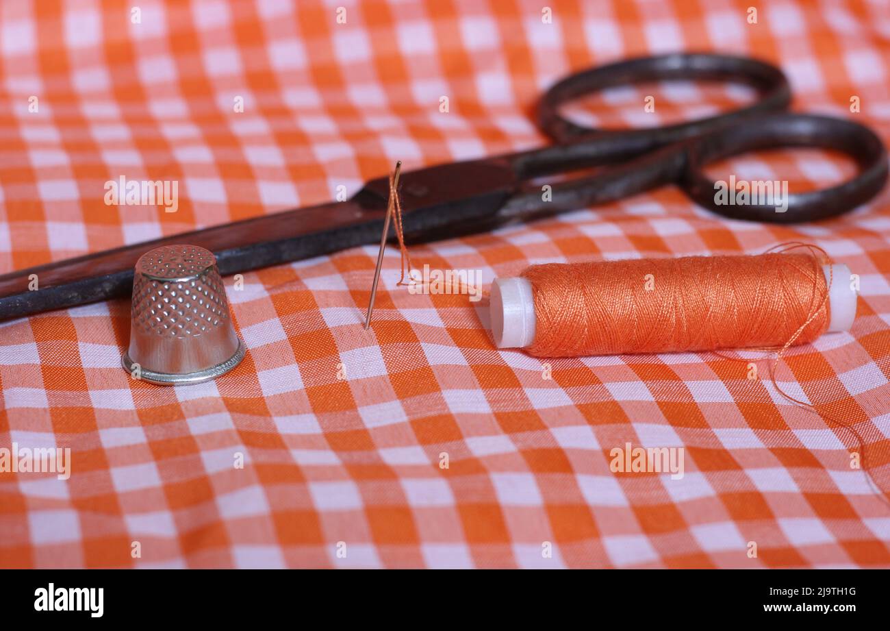 Orange and White Checkered Fabric With Thimble and Spool of Orange ...