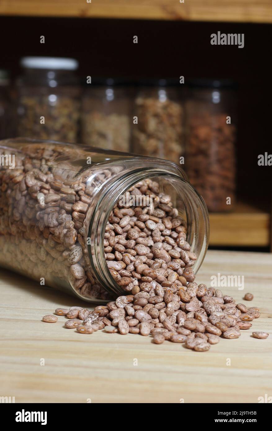 Jar of Pinto Beans Spilled on Kitchen Table With Jars of Beans in ...
