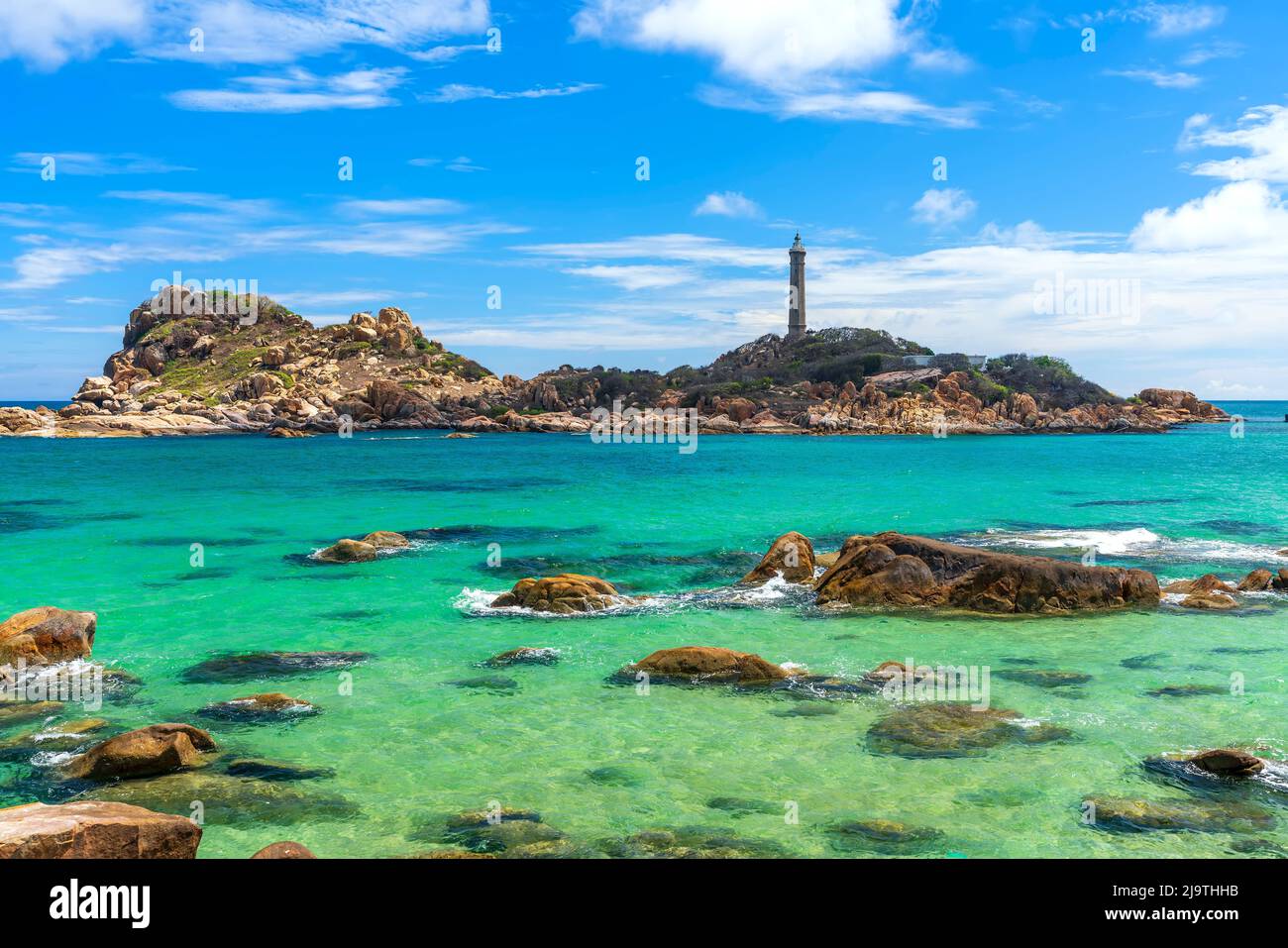 Ke Ga lighthouse is located on an island near the shore seen from above ...