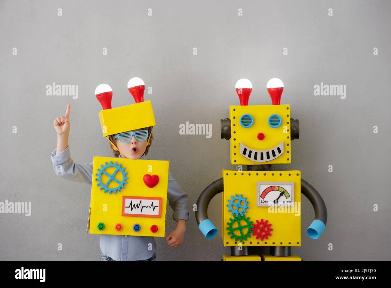 Happy child with robot. Funny kid have an idea. Success, creative and ...
