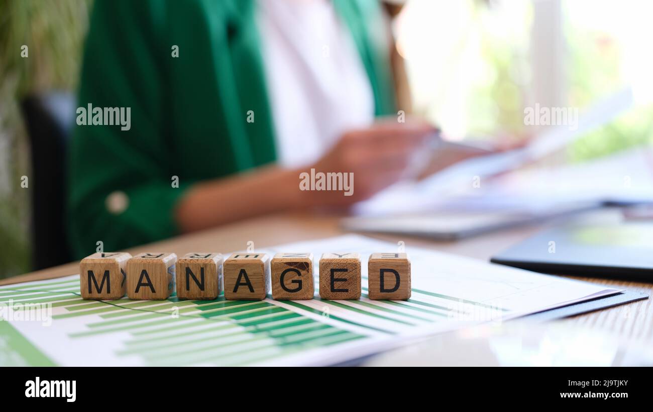 Text on cubes managed and business persons with graphs Stock Photo - Alamy