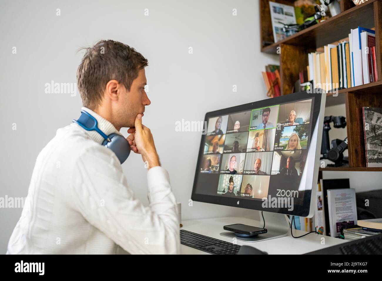 Young man having Zoom video conference call via computer Stock Photo ...