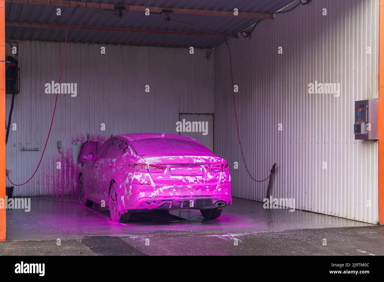 automobile at self-service car wash covered with pink car shampoo Stock ...