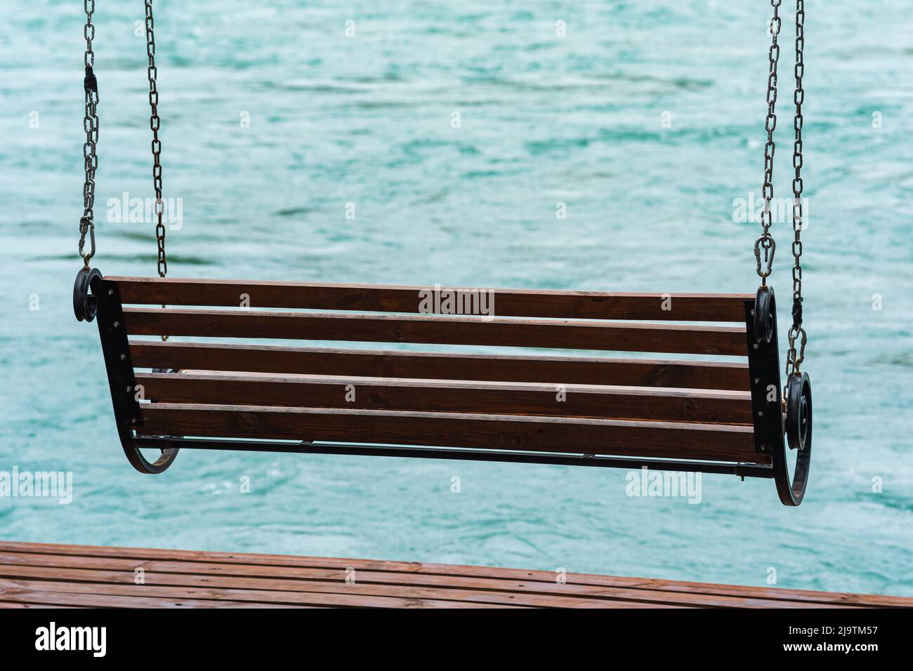 bench-swing over water on the bank of a fast river Stock Photo - Alamy