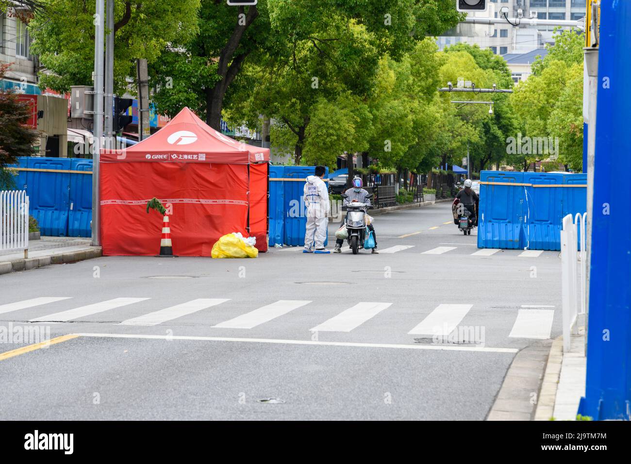 A Minghang district police officer checks the express delivery driver ...
