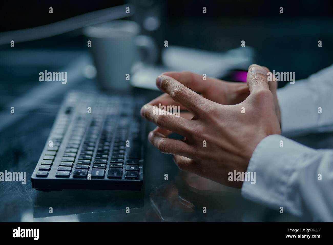 business man sitting at a computer desk . close-up Stock Photo - Alamy