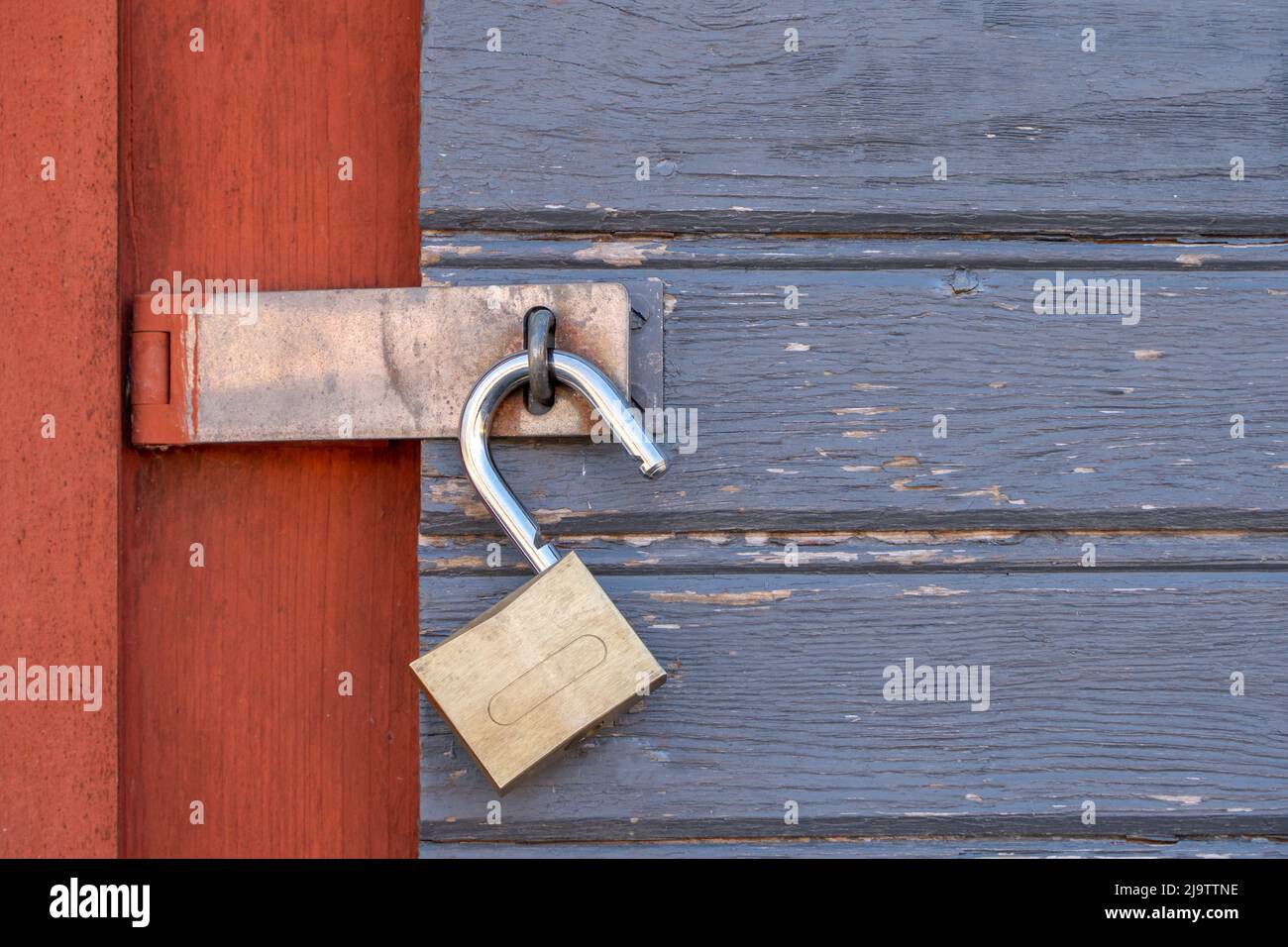 Old unlocked padlock on a wooden door Stock Photo - Alamy