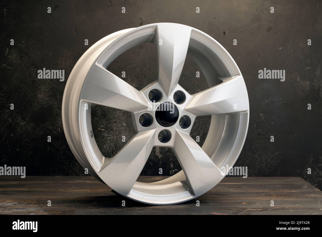 new grey alloy wheels on a dark textured black background. a wheel for ...