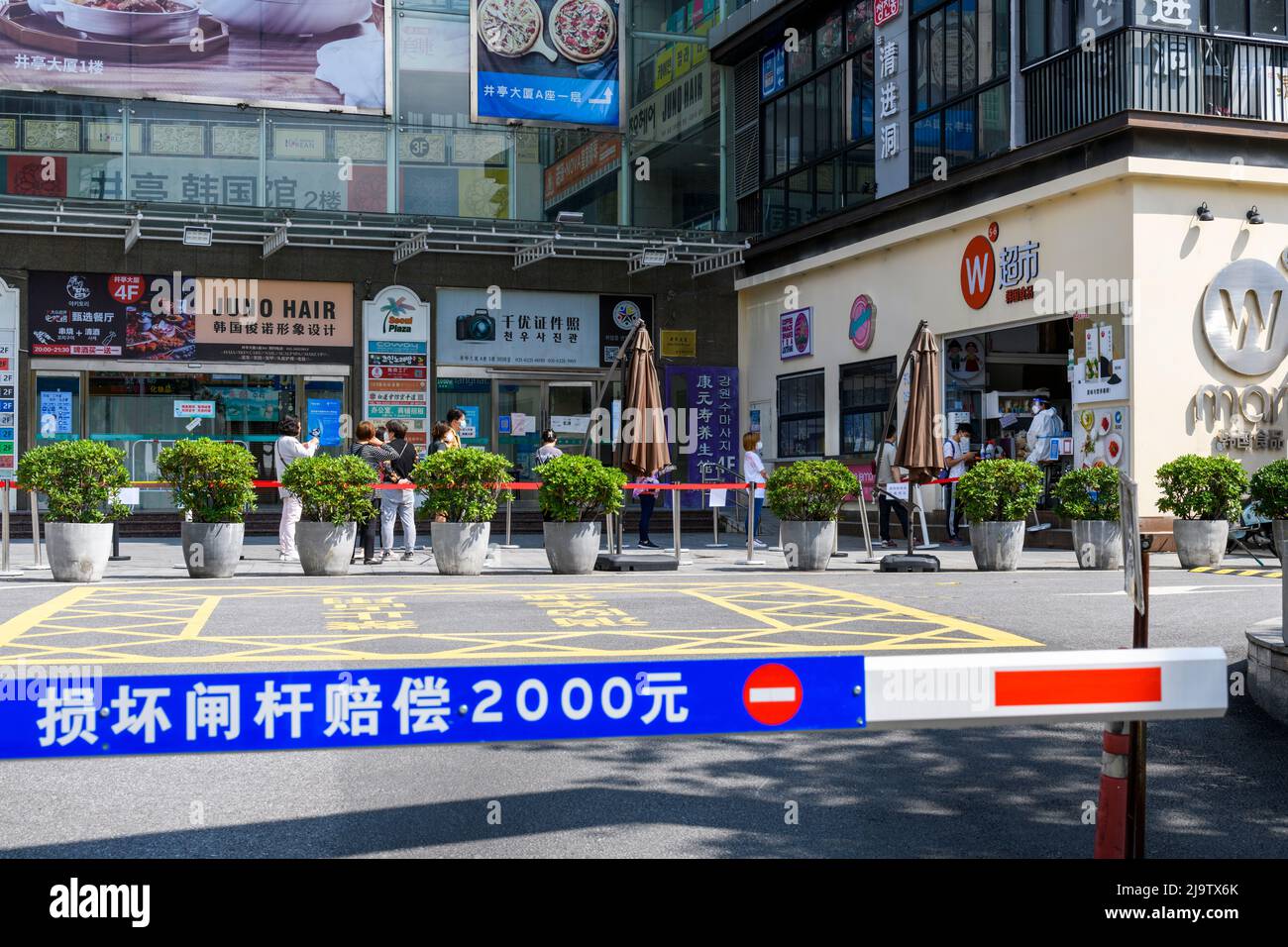 Residents of Korean street in Hongqiao Town neighborhood wait in line ...