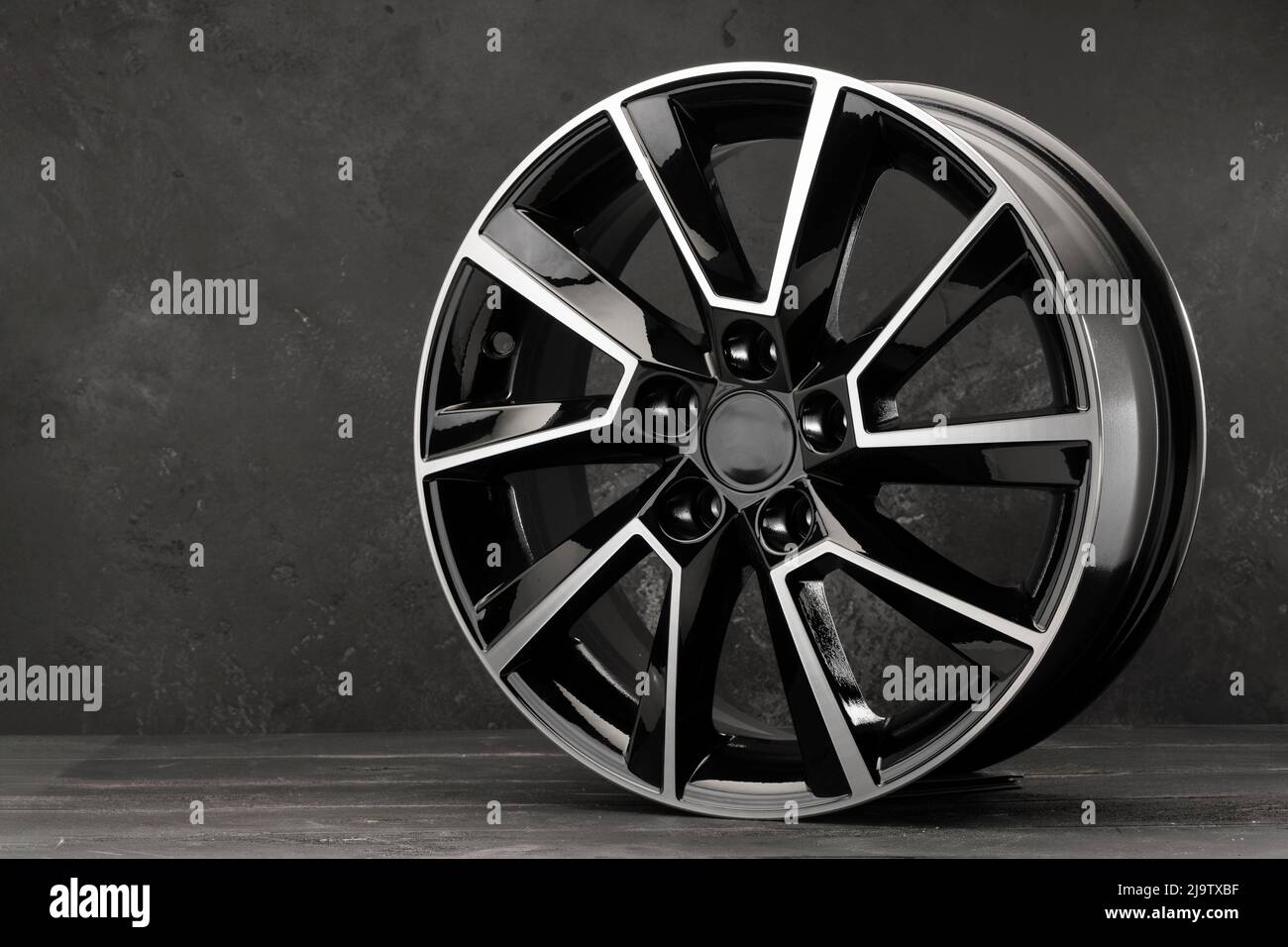 black beautiful alloy wheel on a texturally dark background Stock Photo ...