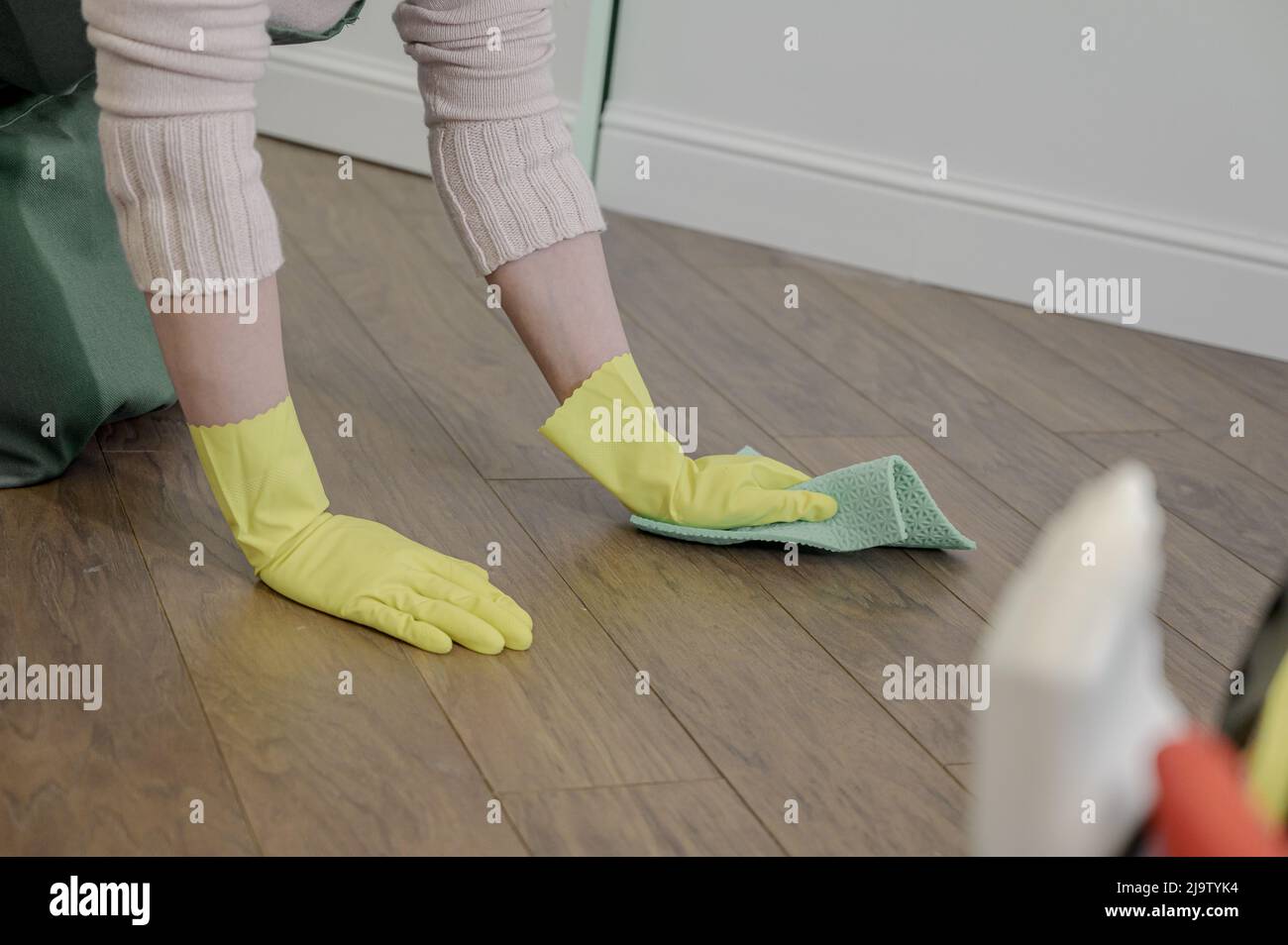a woman washes the floor with a rag with detergents. house cleaning ...