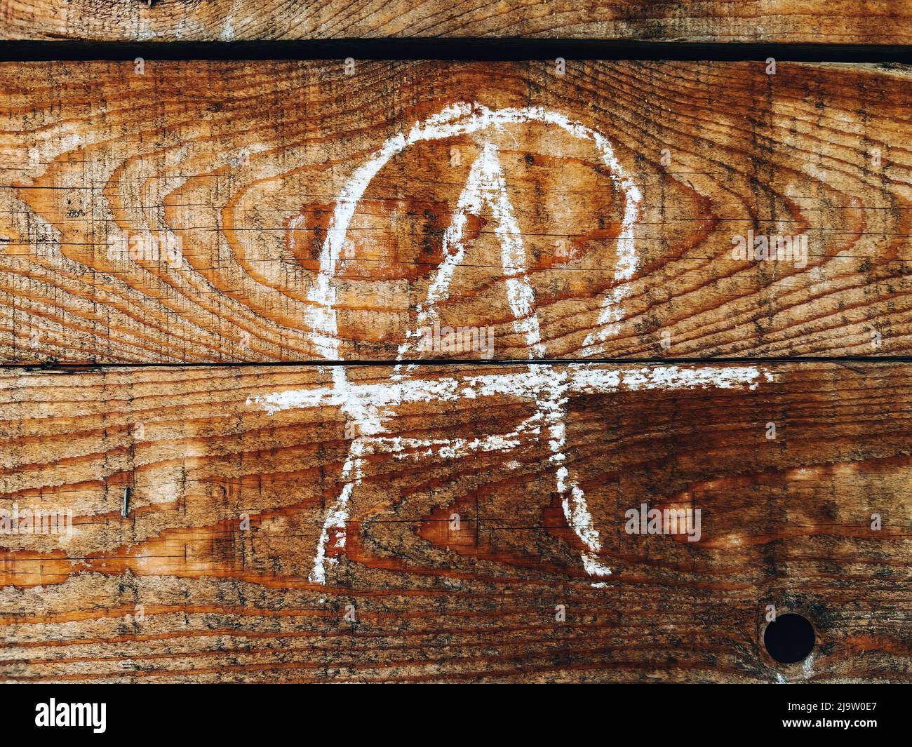 Anarchist symbol on wooden wall written in chalk Stock Photo - Alamy