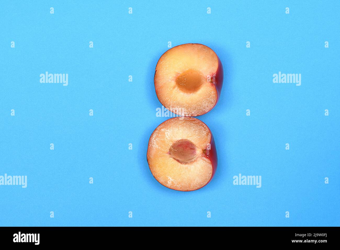 Ripe plum fruit isolated on blue background. High resolution photo ...