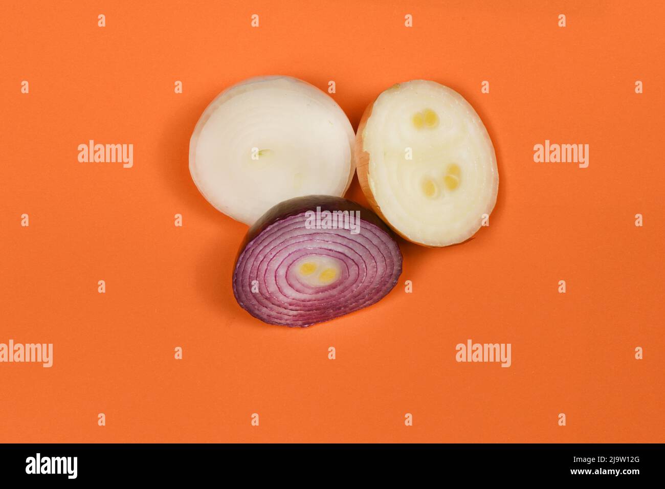 Three sliced onion of different colors (red, yellow and white) isolated ...
