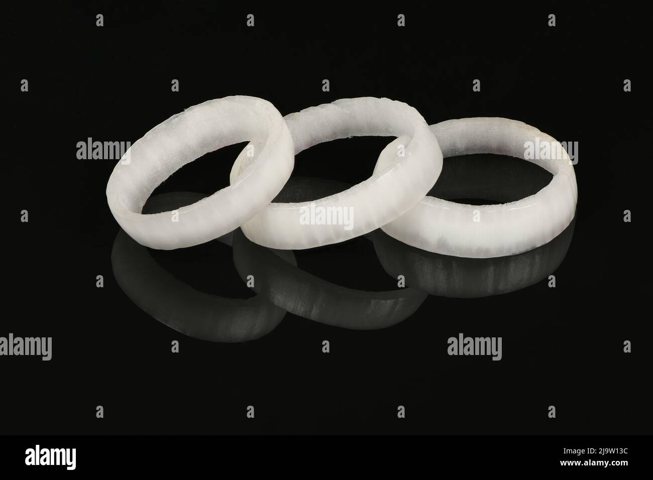 Sliced white onion rings isolated on acrylic black background. High ...