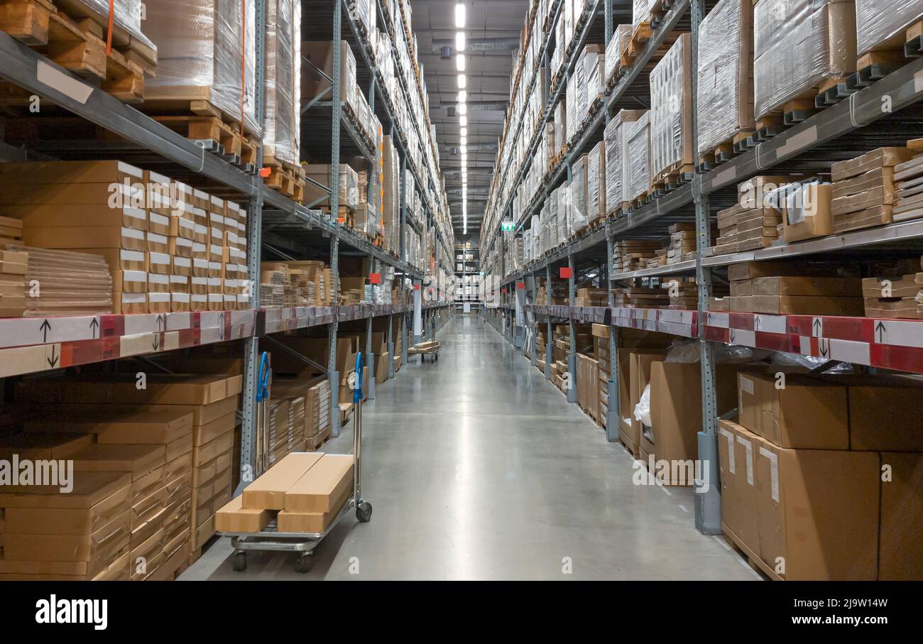Distribution warehouse interior. Shelve with boxes in modern factory ...