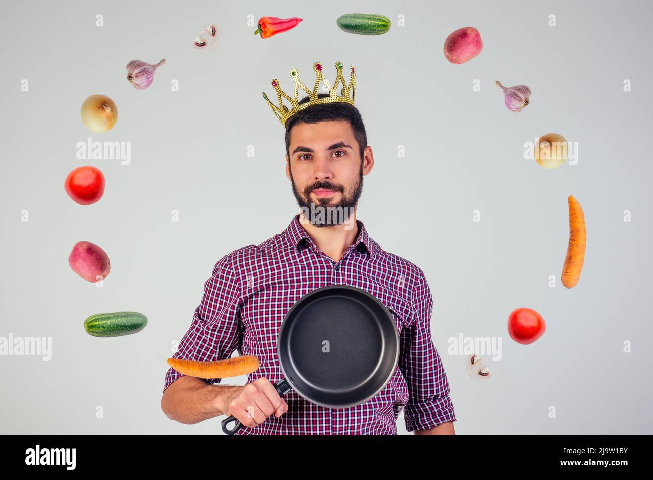 king of the kitchen with a golden crown on head chef holding a frying ...