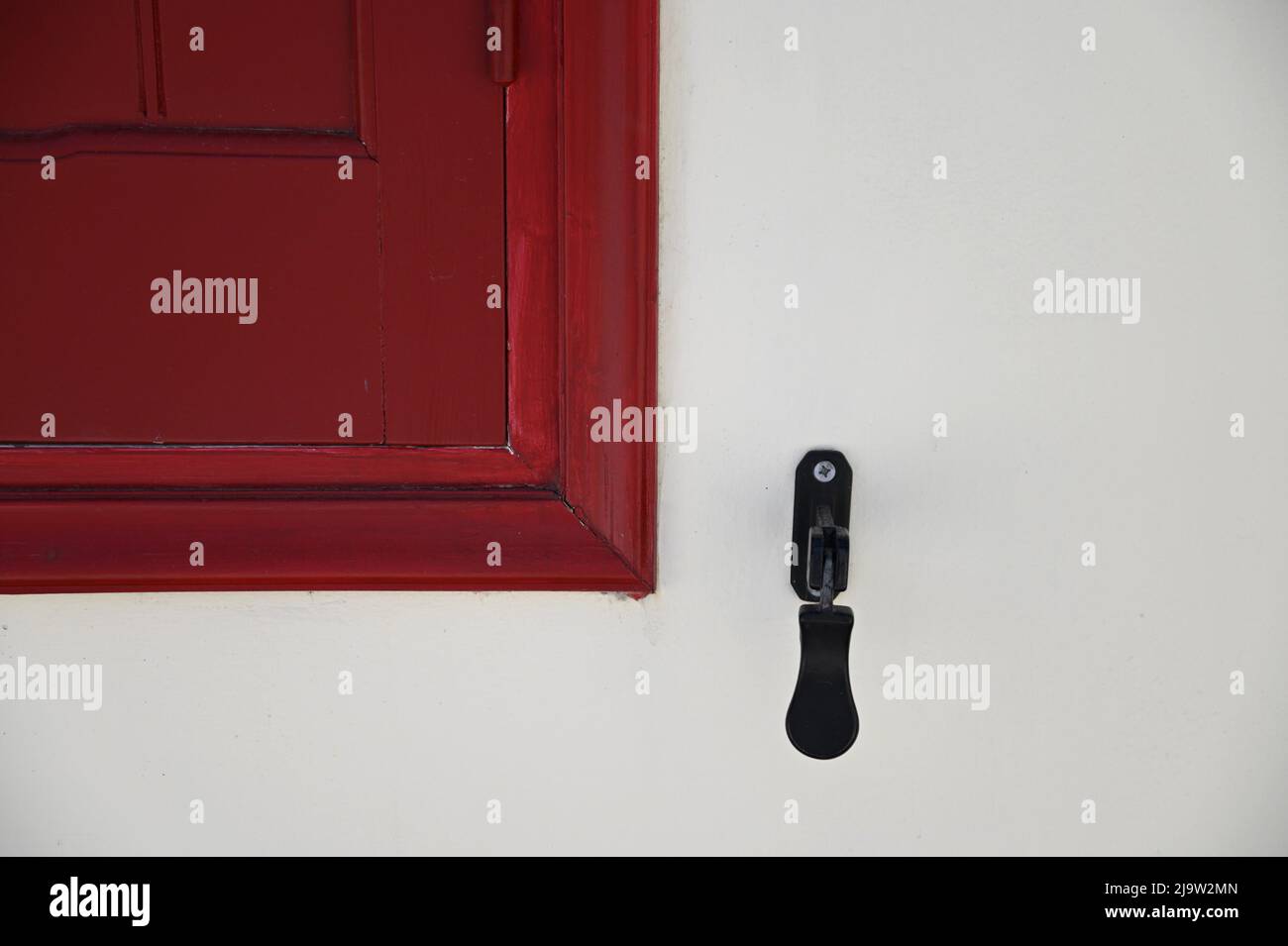 Traditional rural house Crimson red wooden window shutters with a ...