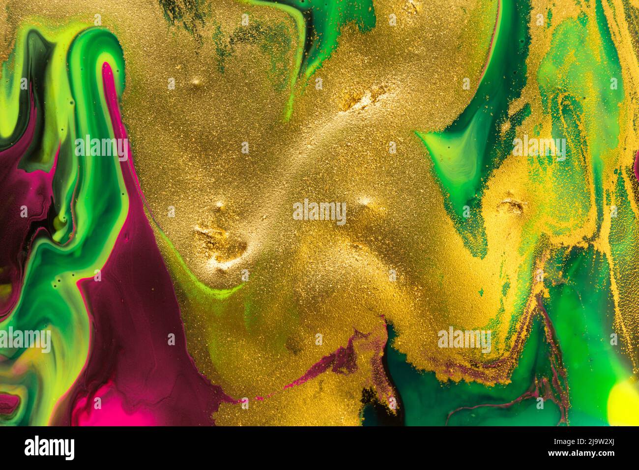 Gold dust spots on liquid fluorescent paints background Stock Photo - Alamy