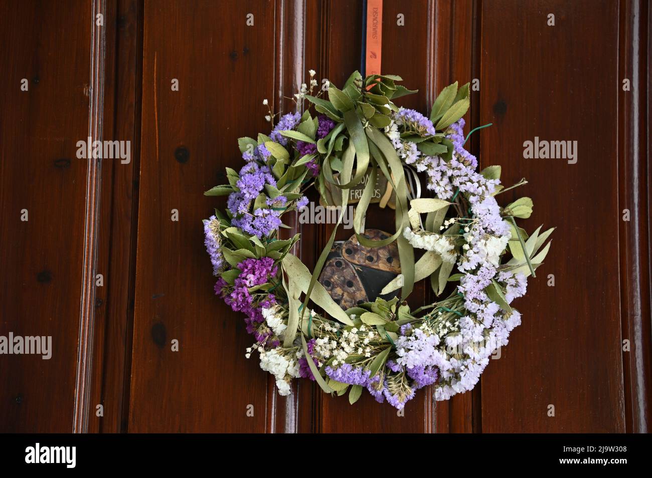 Traditional May wreath with dried amaranth flowers, laurel leaves and ...