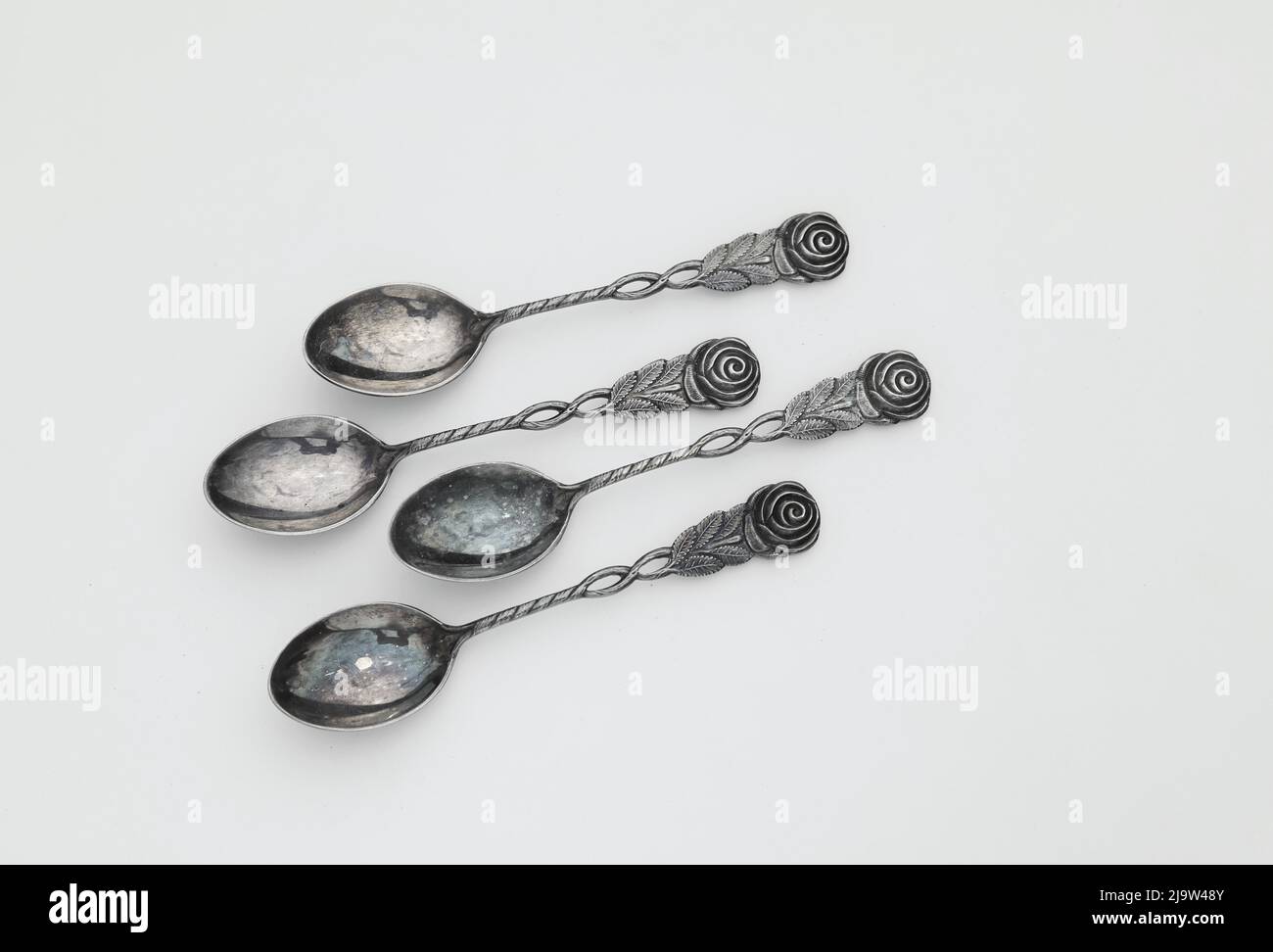 Antique ornate silverware small spoons Stock Photo - Alamy