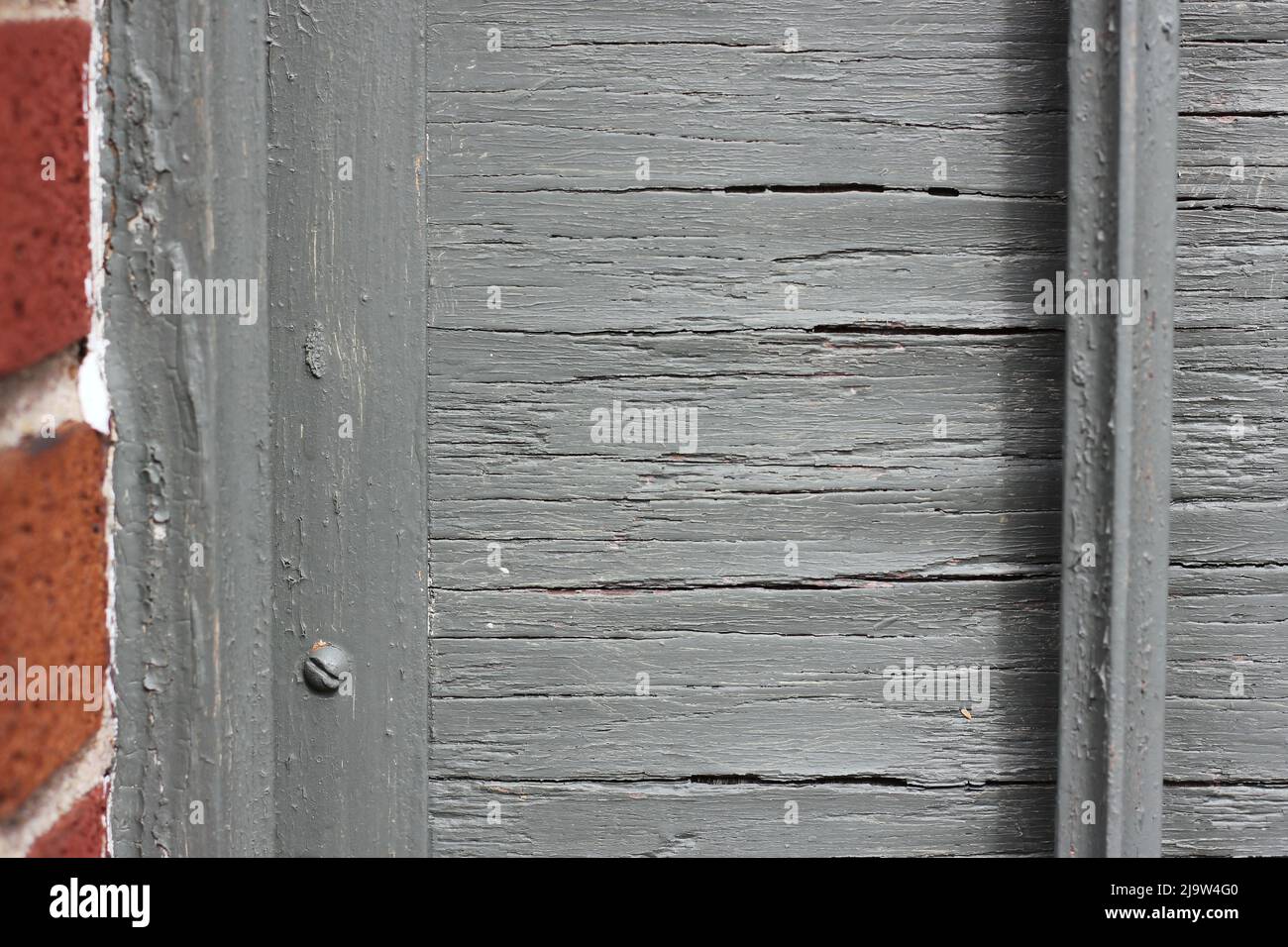 Worn and cracked wooden board used as infill for a broken window Stock ...