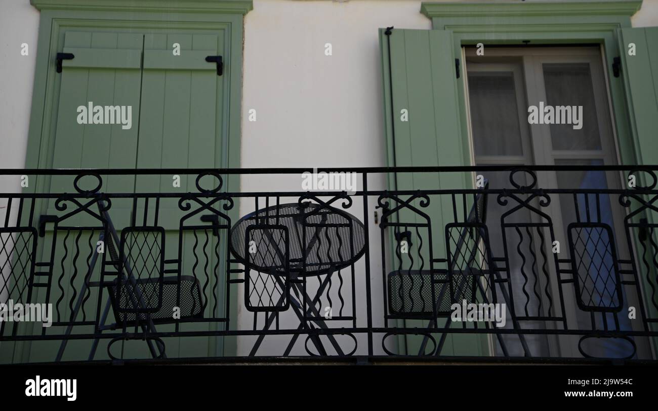Traditional rural house facade with olive green wooden shutters a ...