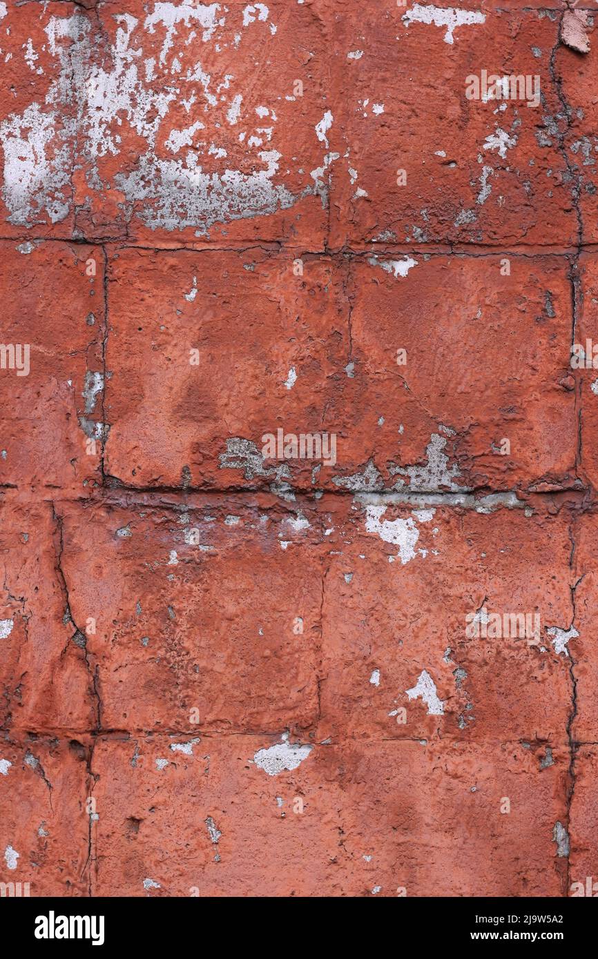 Old busted weathered worn concrete block wall in rustic red Stock Photo ...