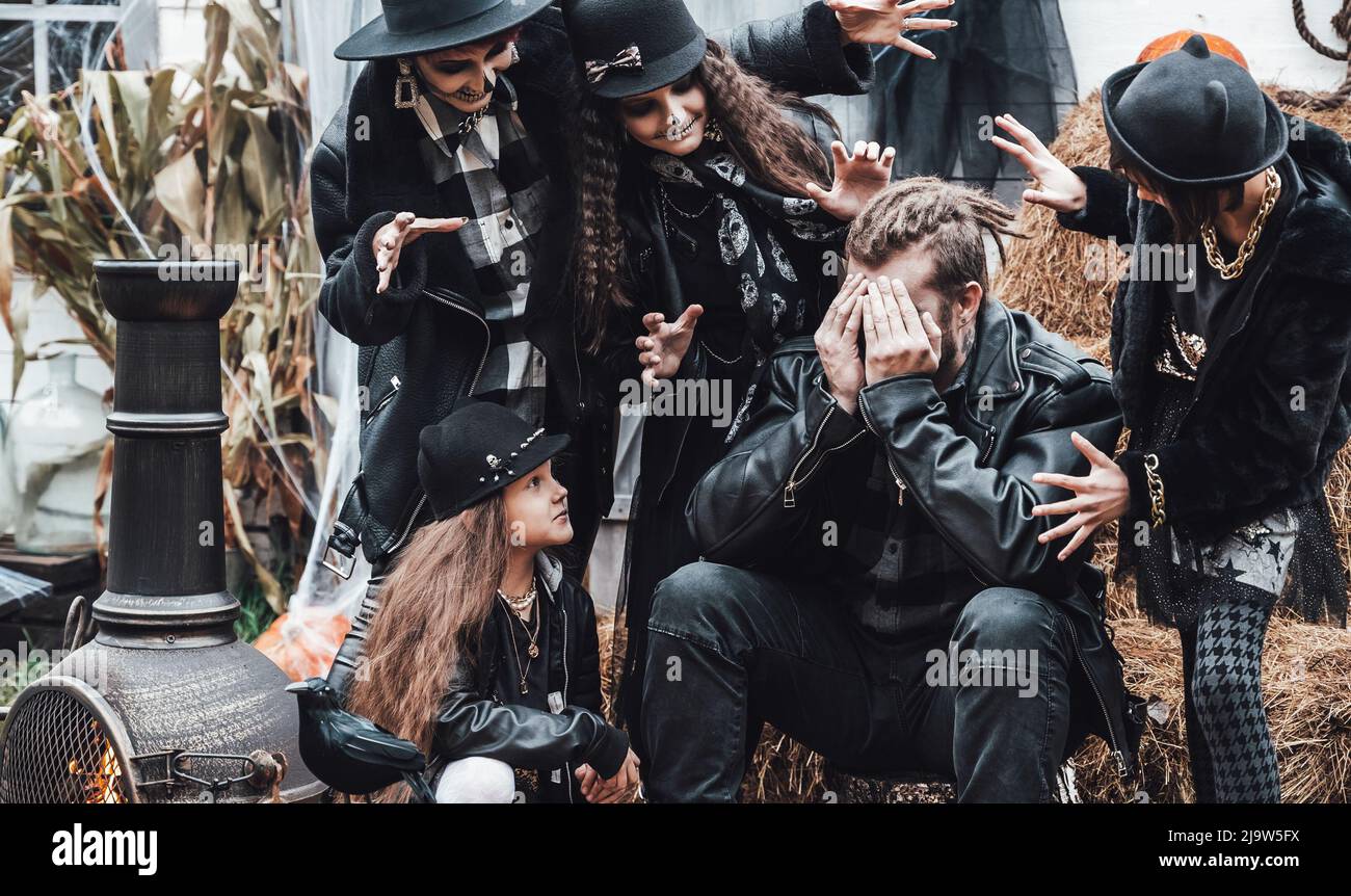 Scary family, mother, father, daughters celebrating halloween ...