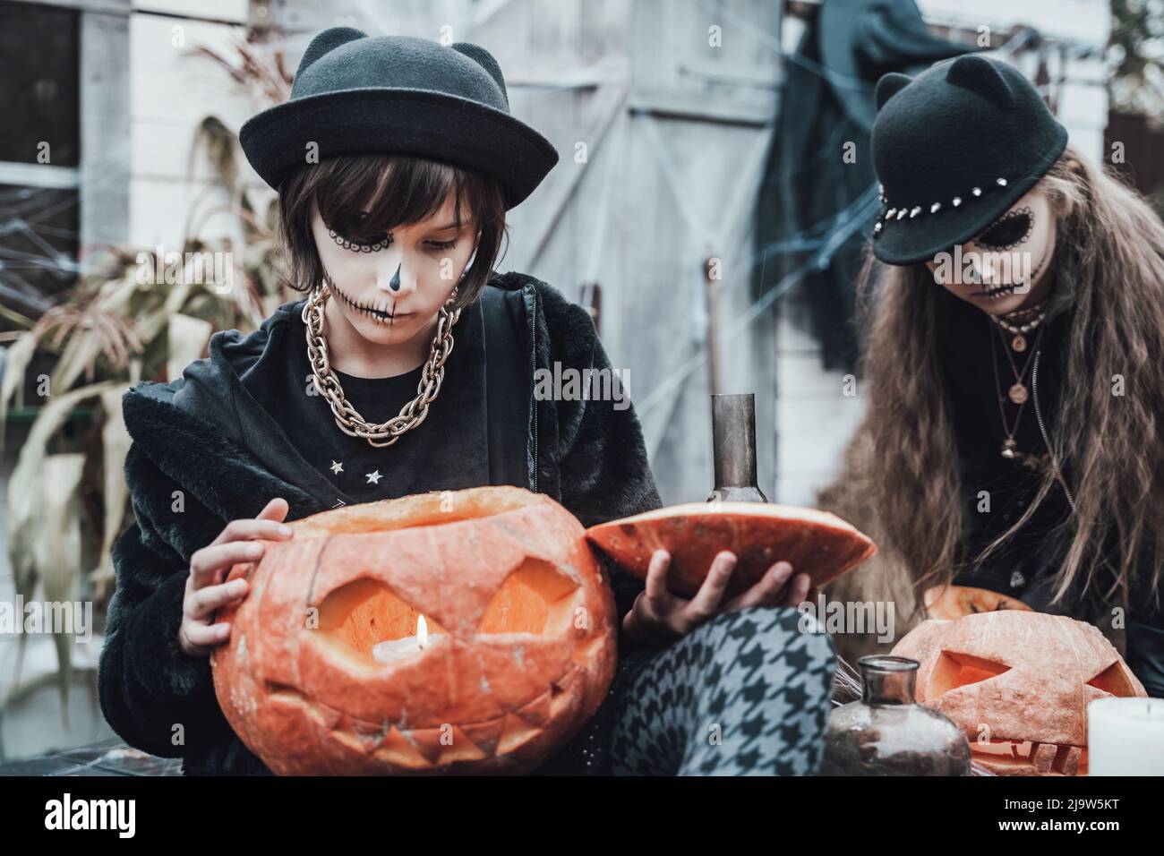 Scary little girls, sisters celebrating halloween. Pumpkin jack-o ...