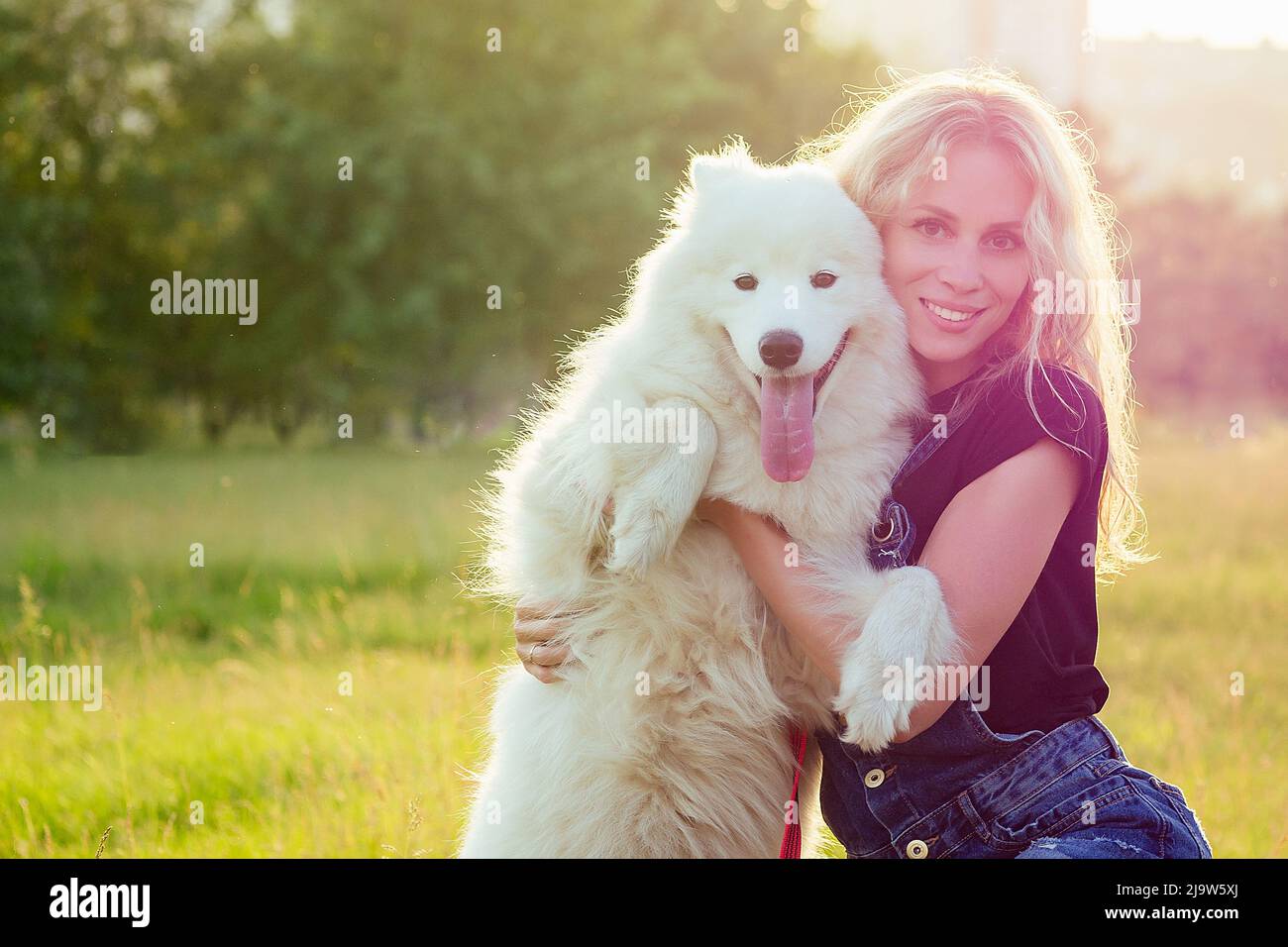 beautiful and charming curly blonde smiling toothy woman in denim ...