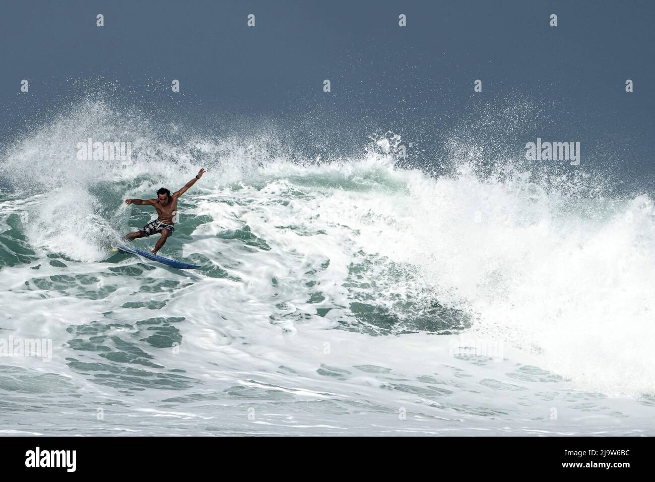West Java, Indonesia. 25th May, 2022. A surfer rides a wave at Cimaja ...