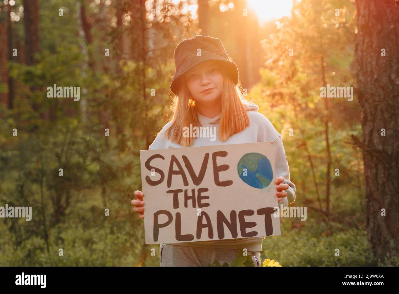 Teenager kid with encouraging save the planet poster agitating in ...