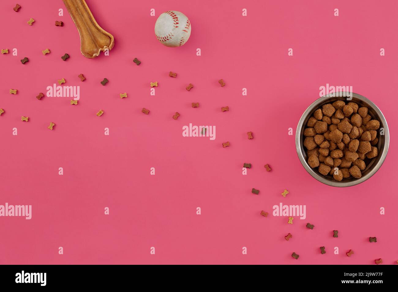 Dog snacks, dog chews, dog bone, ball toy for dog on a pink background ...