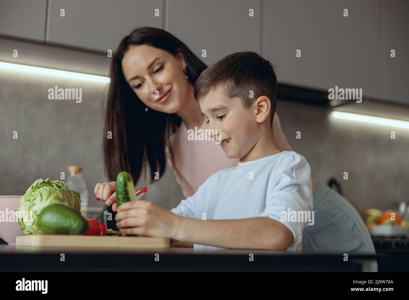 Son helping mother cook hi-res stock photography and images - Alamy
