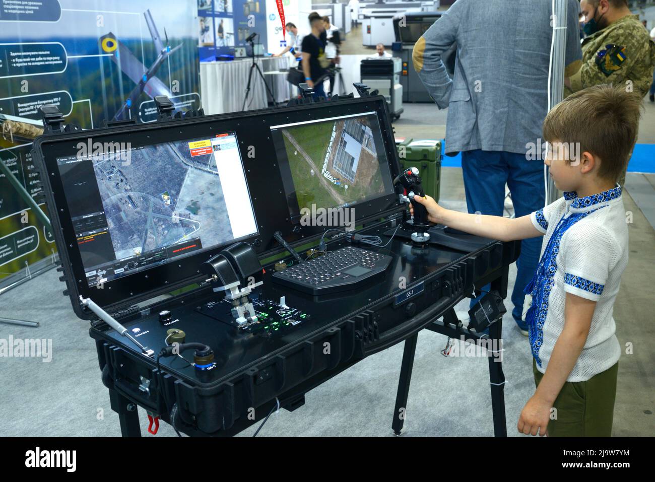 Little boy playing with control panel station for an unmanned aerial ...