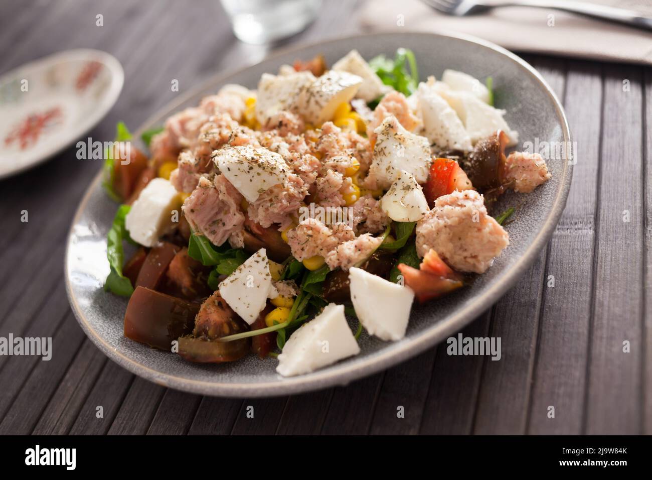 Fish salad with canned tuna and corn, tomatoes and arugula Stock Photo ...