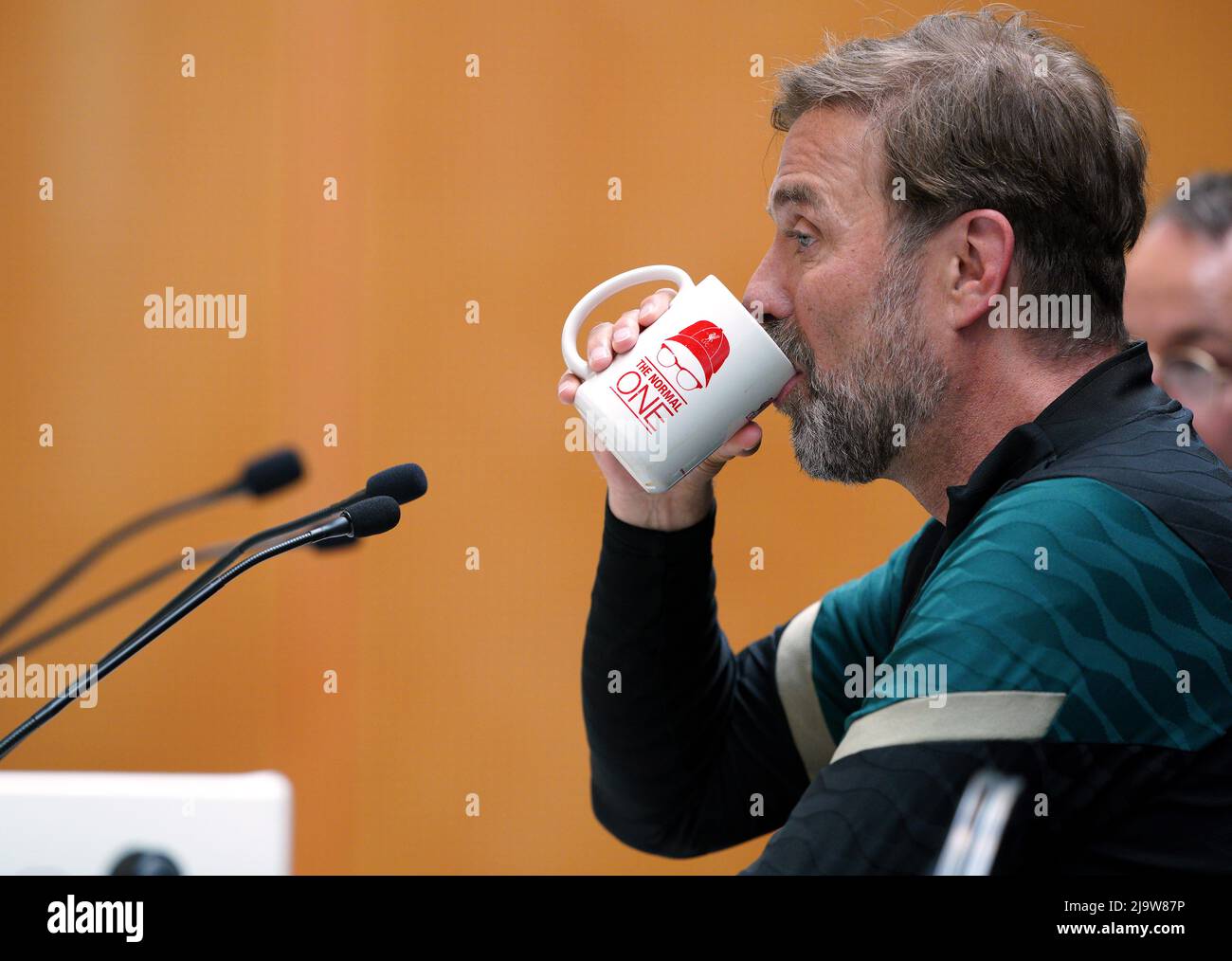 Liverpool manager Jurgen Klopp using a mug with The Normal One on it ...