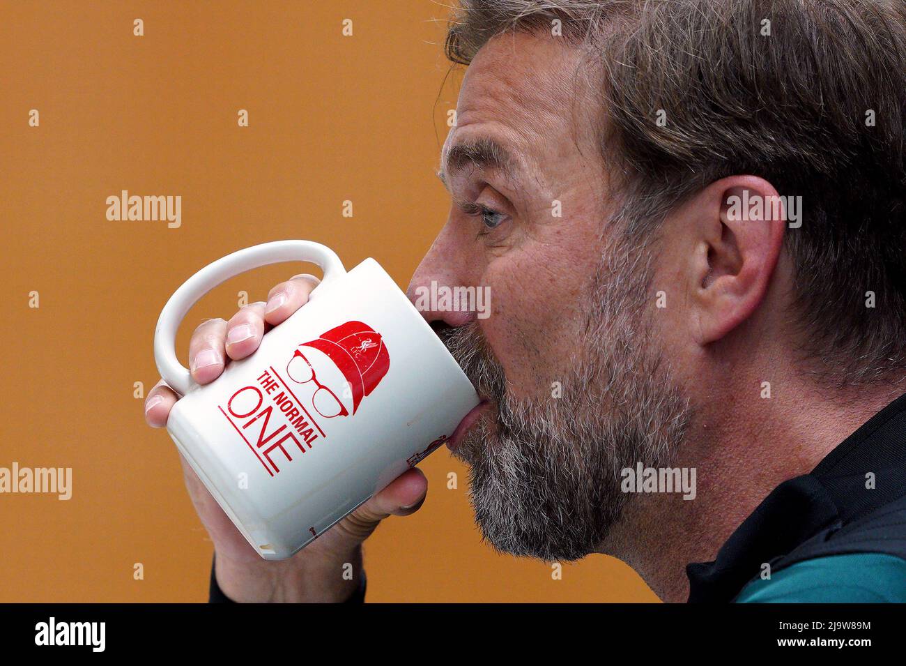 Liverpool manager Jurgen Klopp using a mug with The Normal One on it ...
