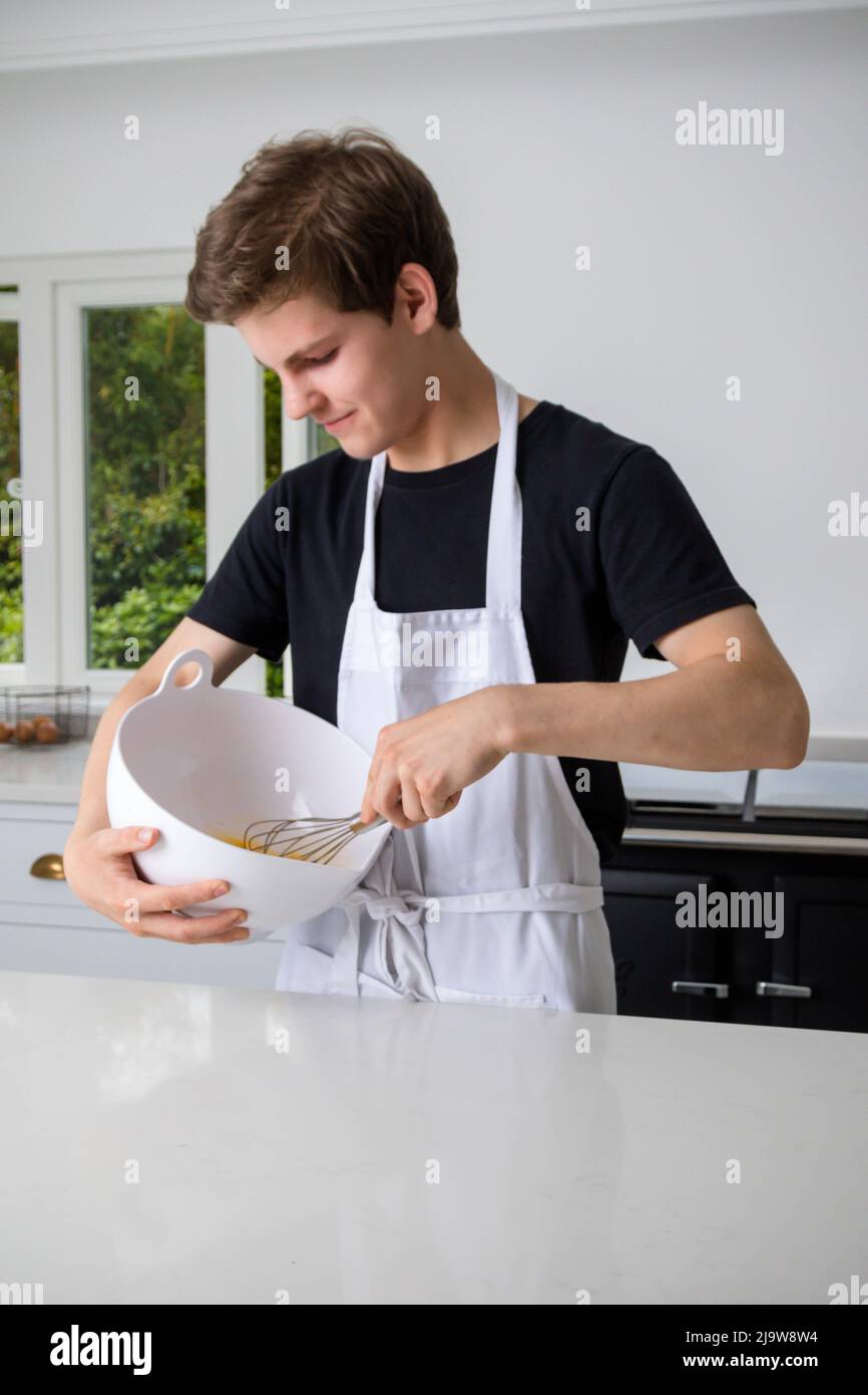 Teenager cooking eggs hi-res stock photography and images - Alamy