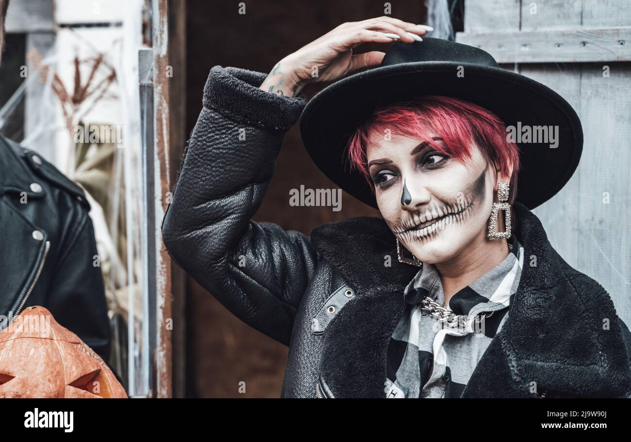 Scary woman, girl celebrating halloween.Terrifying black skull half ...