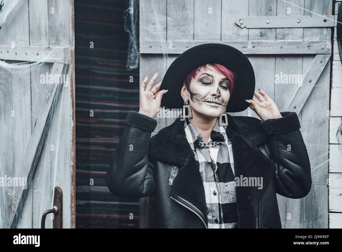 Scary woman, girl celebrating halloween.Terrifying black skull half ...