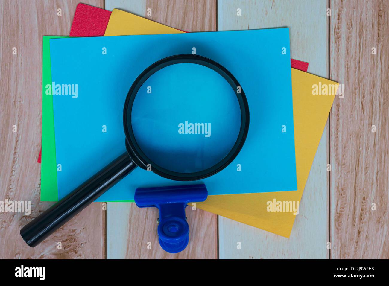 Colorful Adhesive Note With Magnifying Glass On Wooden Desk. Business ...