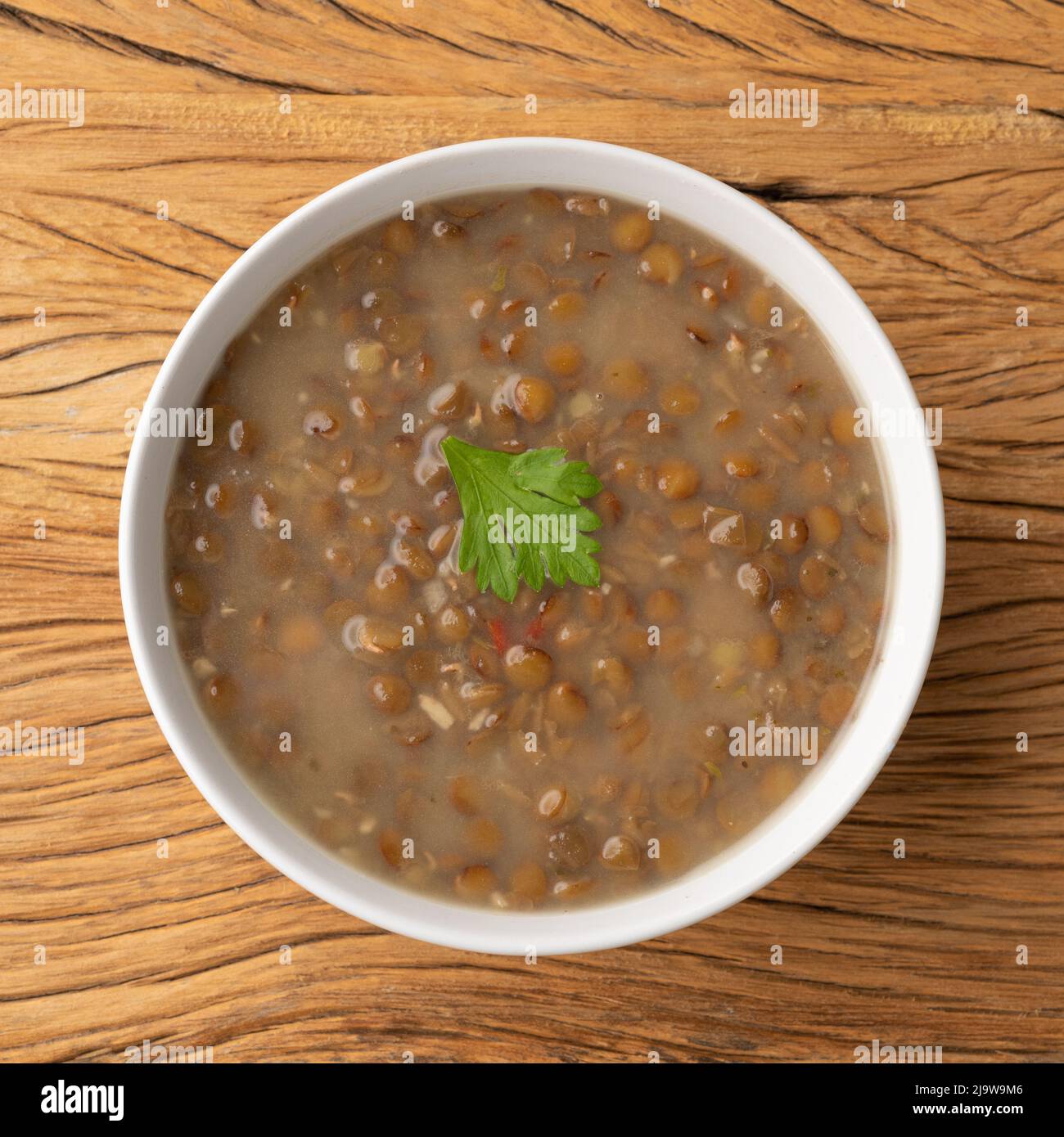Lentil soup in a bowl with seasoning over wooden table Stock Photo - Alamy