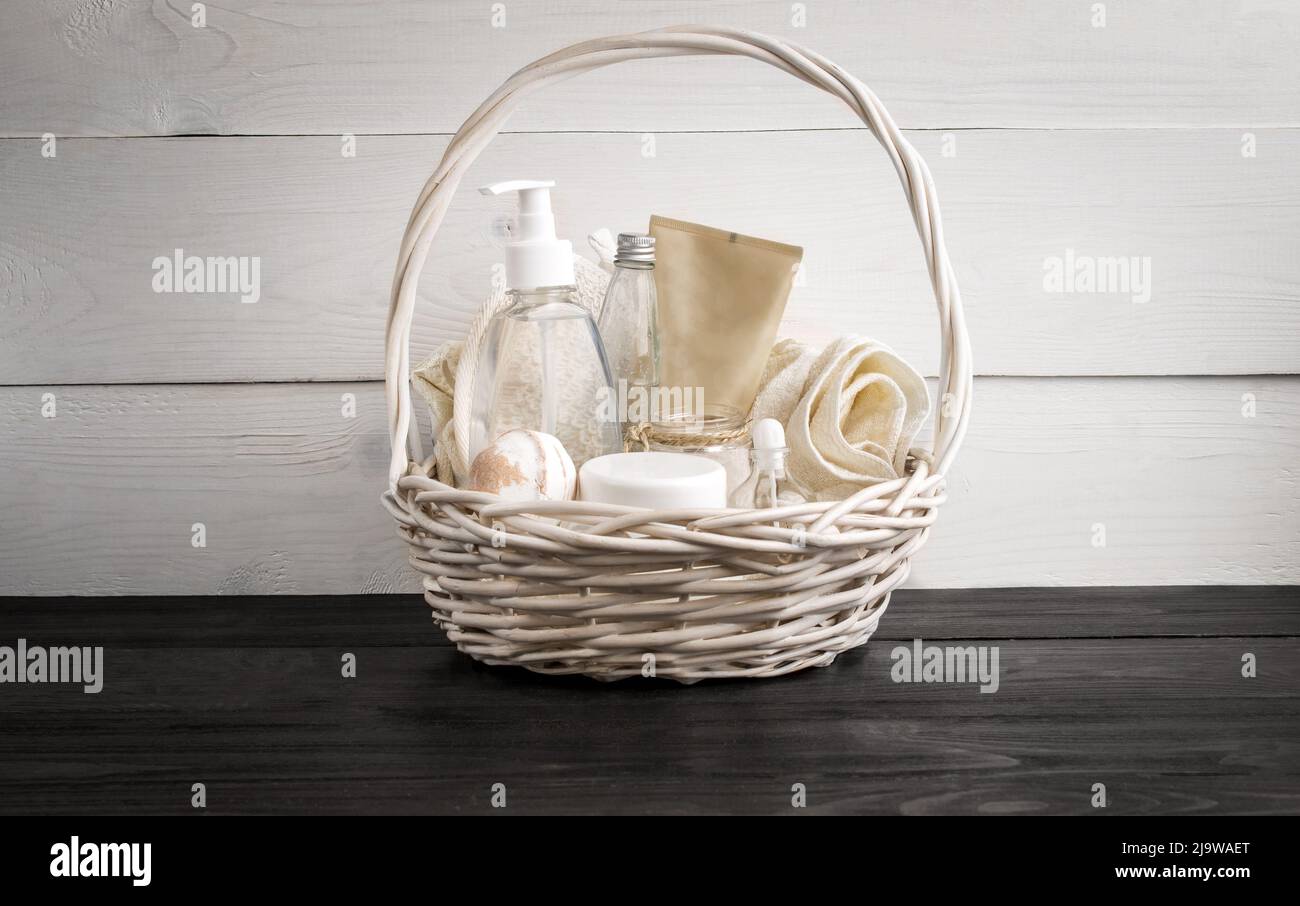 Wicker basket with spa treatments on table Stock Photo - Alamy
