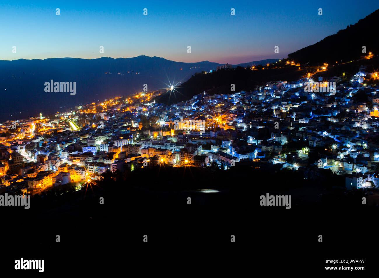Cityscape of the blue city Chefchaouen by night Stock Photo - Alamy
