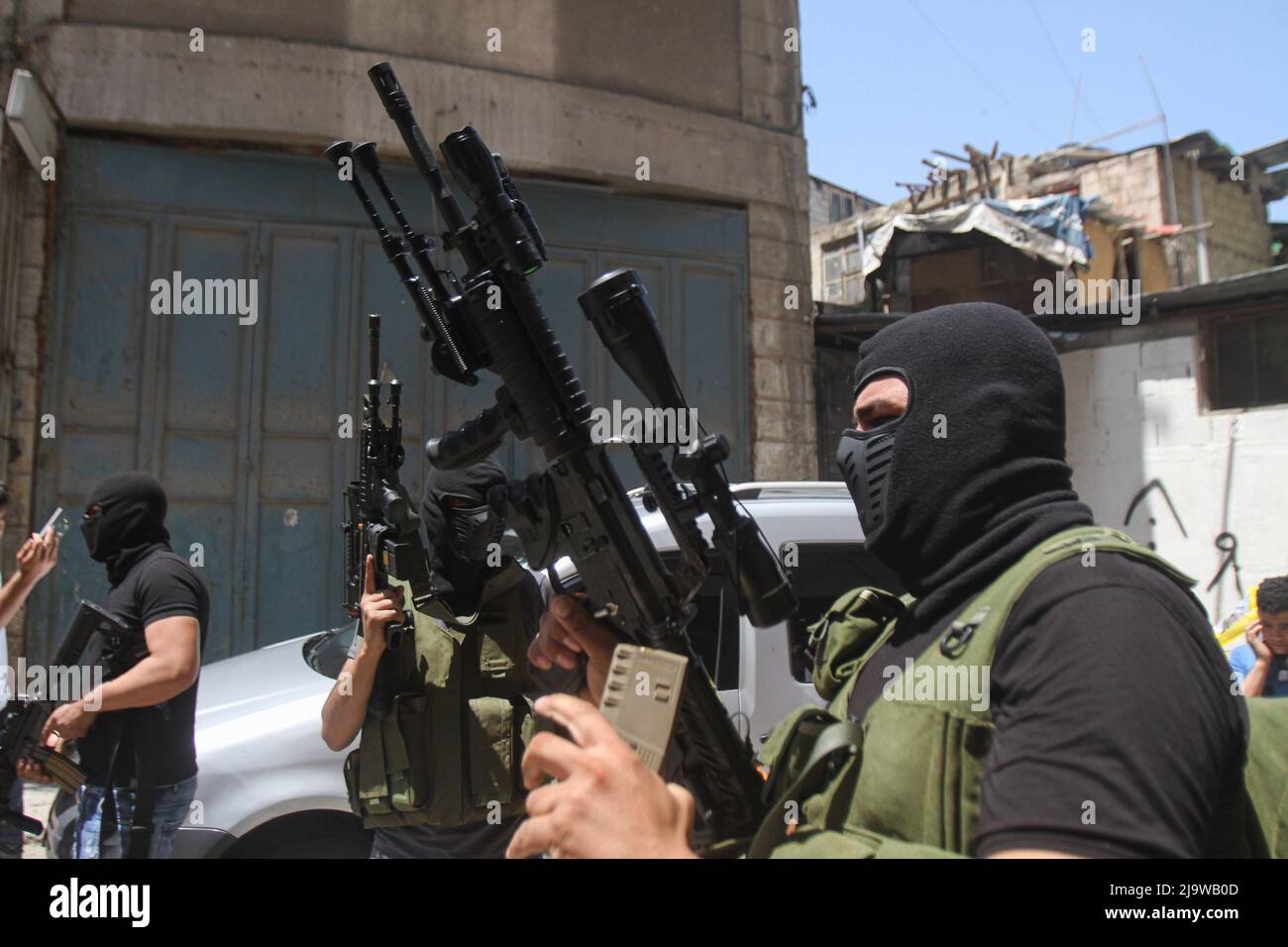 Masked Palestinian gunmen participate in the funeral of the 16-year-old ...