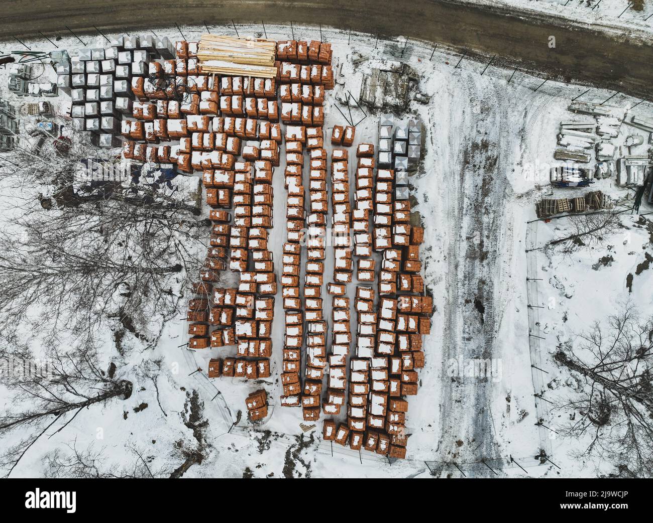Pallets of bricks for construction. Outdoor storage in winter ...
