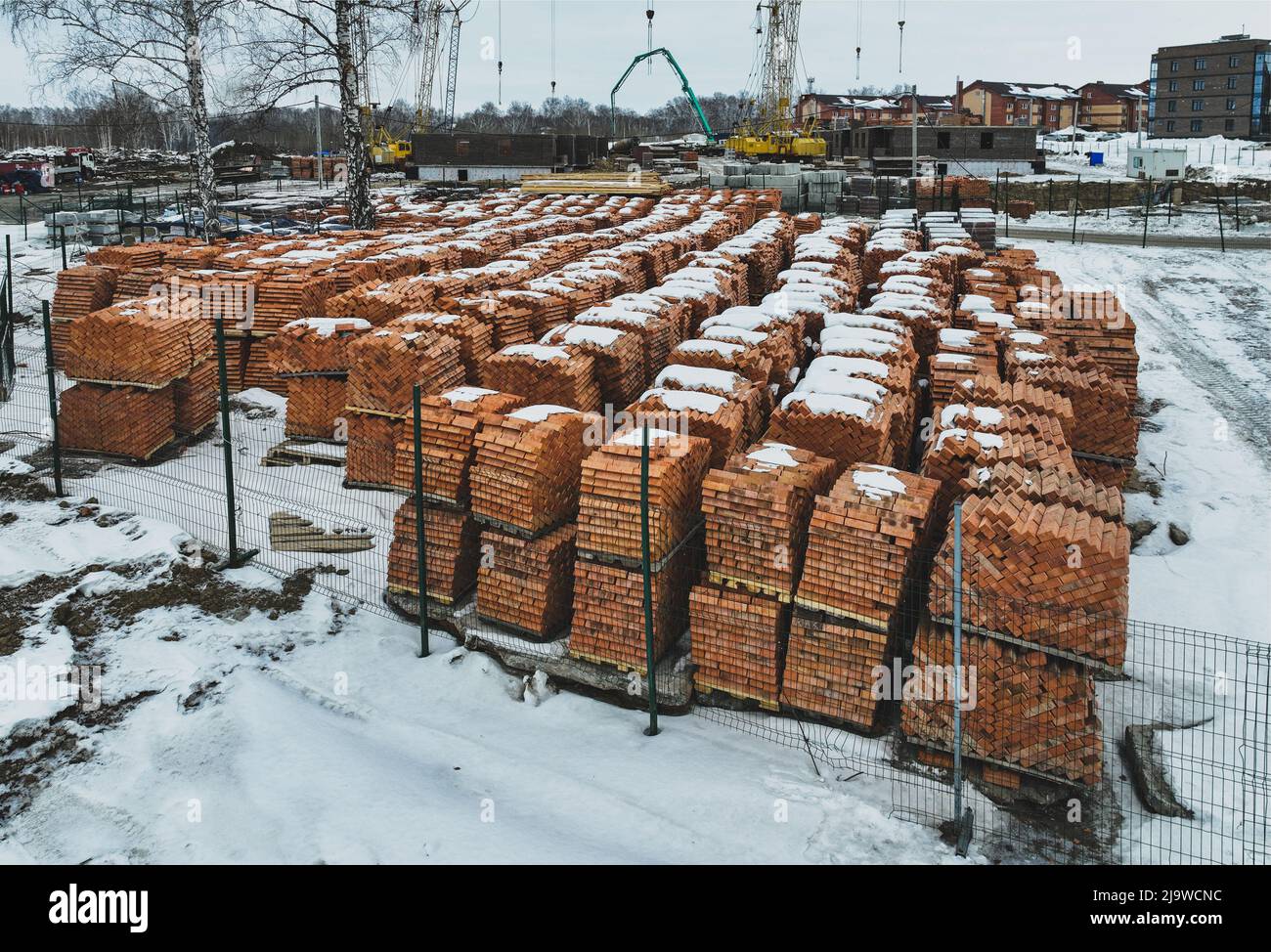 Pallets of bricks for construction. Outdoor storage in winter ...