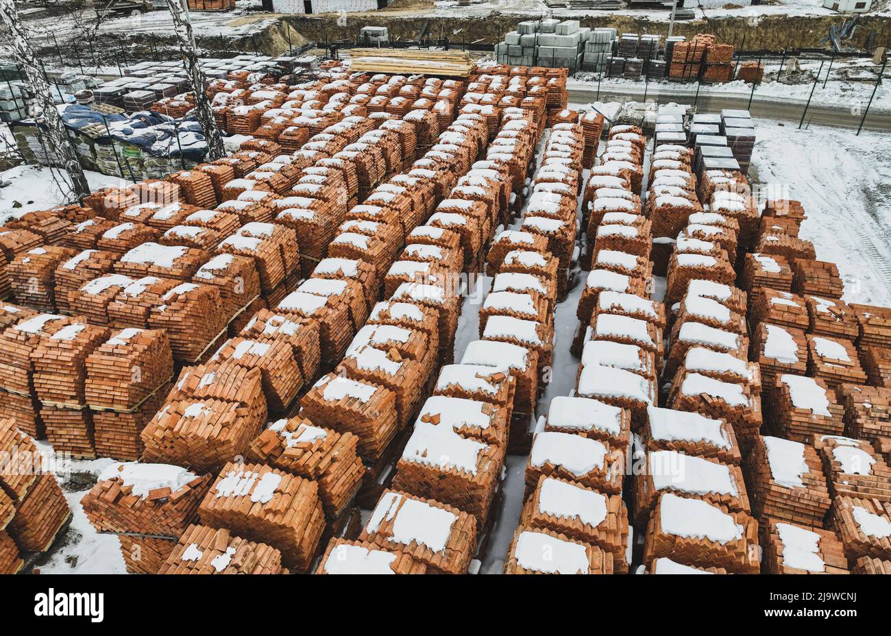 Pallets of bricks for construction. Outdoor storage in winter ...